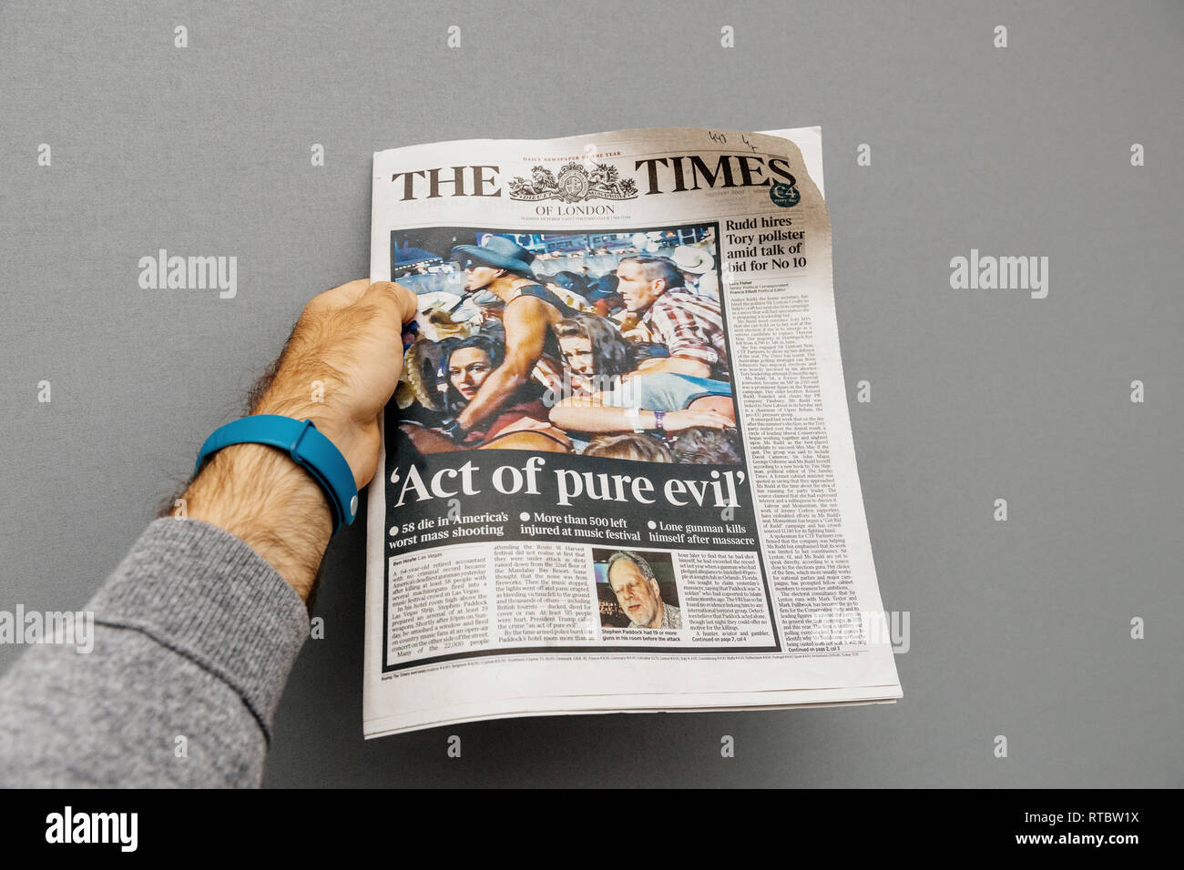 PARIS, FRANCE - OCT 3, 2017: Man holding The Times newspaper cover with ...