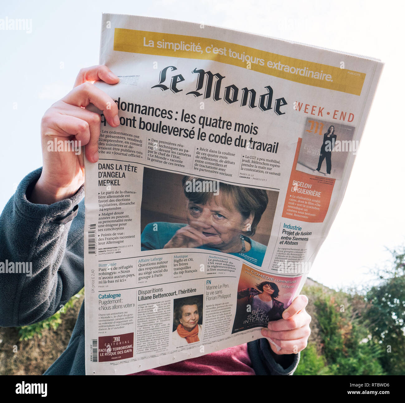PARIS, FRANCE - SEP 24, 2017: View from below of woman reading latest ...