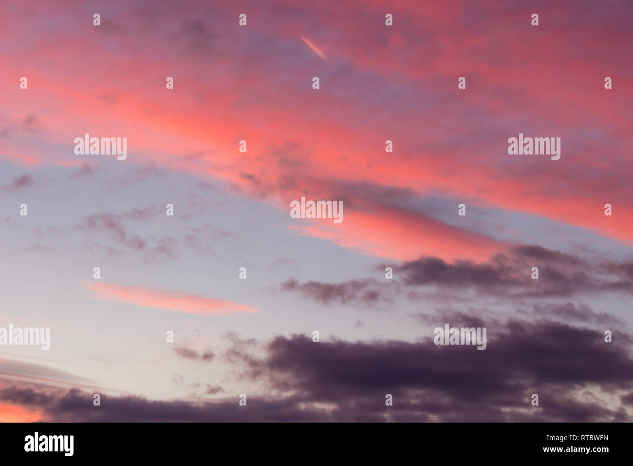Amazing vivid colors of a sunlit, contrasty clouds on a sunset sky and ...