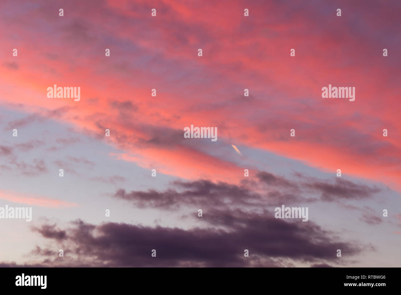 Amazing vivid colors of a sunlit, contrasty clouds on a sunset sky and ...
