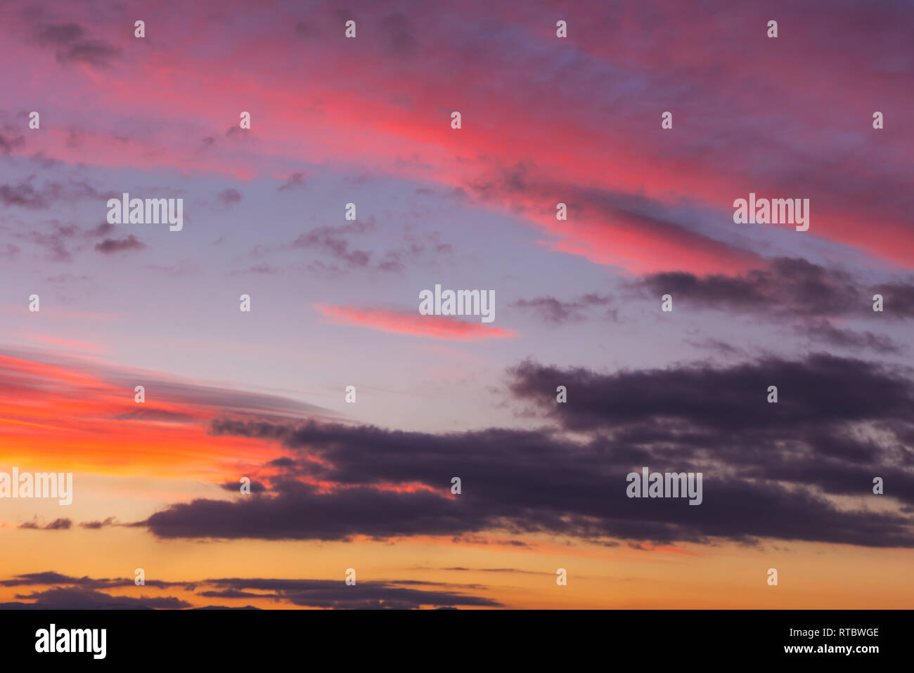 Amazing vivid colors of a sunlit, contrasty clouds on a sunset sky ...
