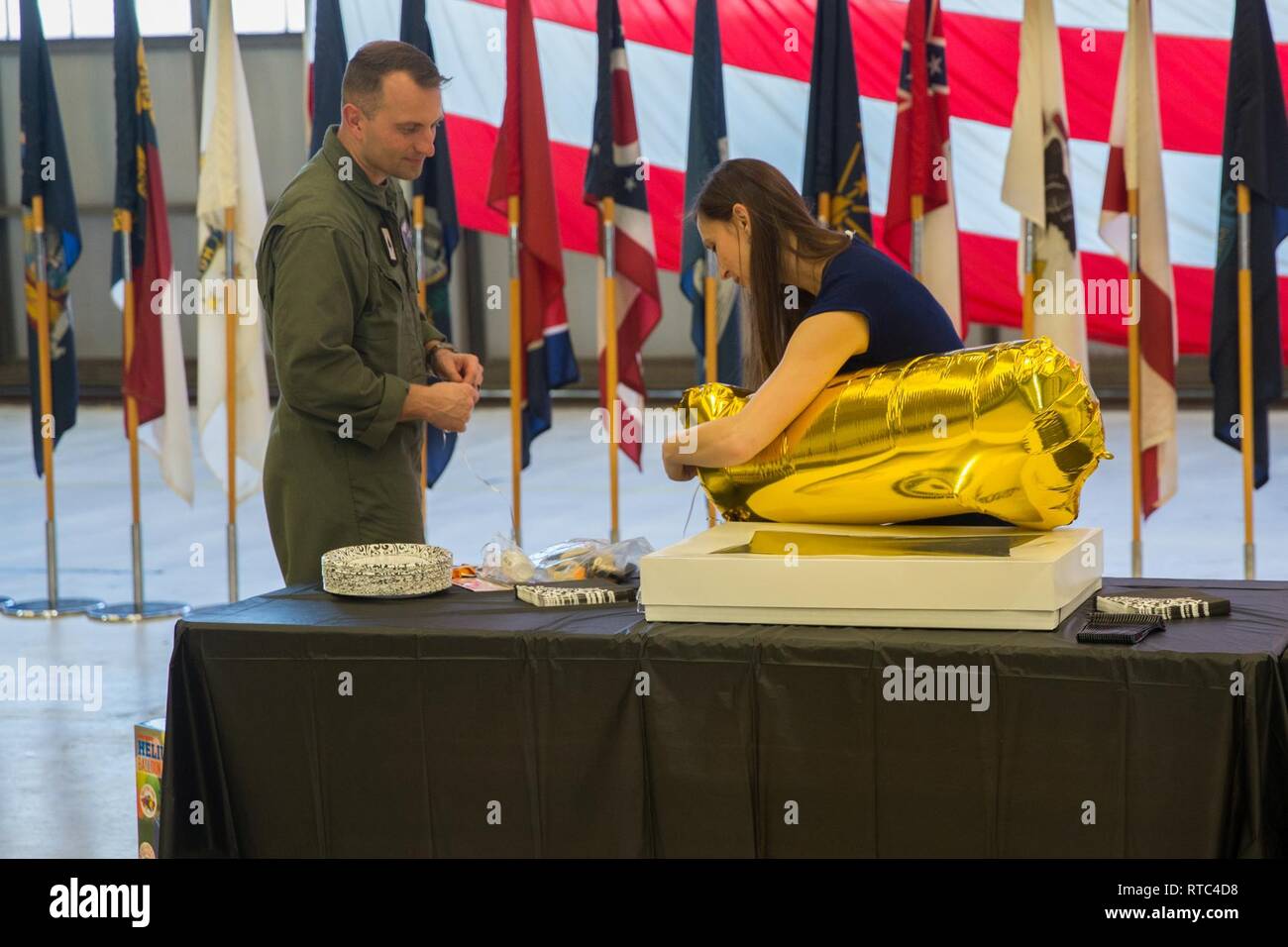 U.S. Marine Lt. Col. Arthur Bruggeman and his spouse set up a table ...
