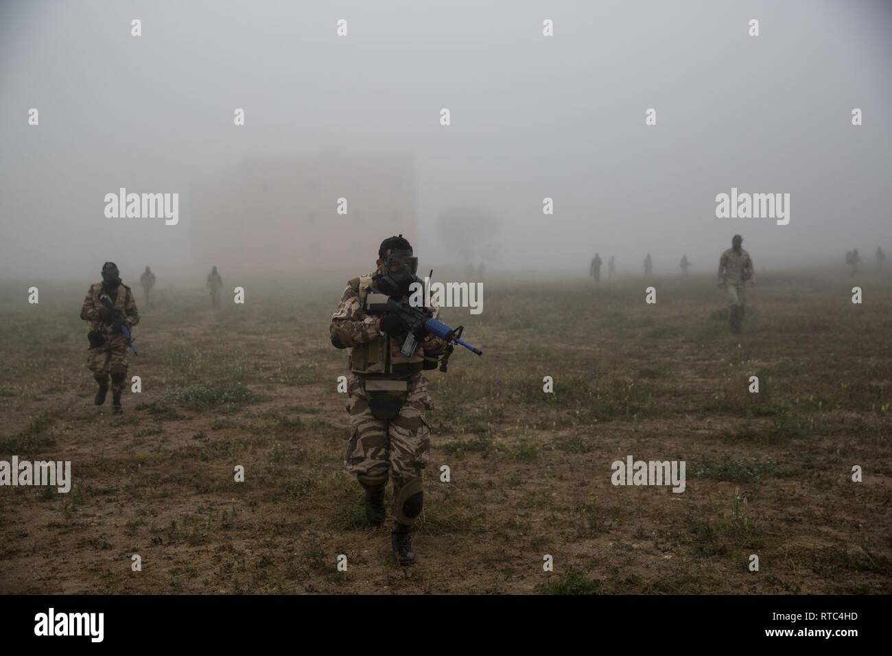 Moroccan special operations forces bound through a field while U.S ...