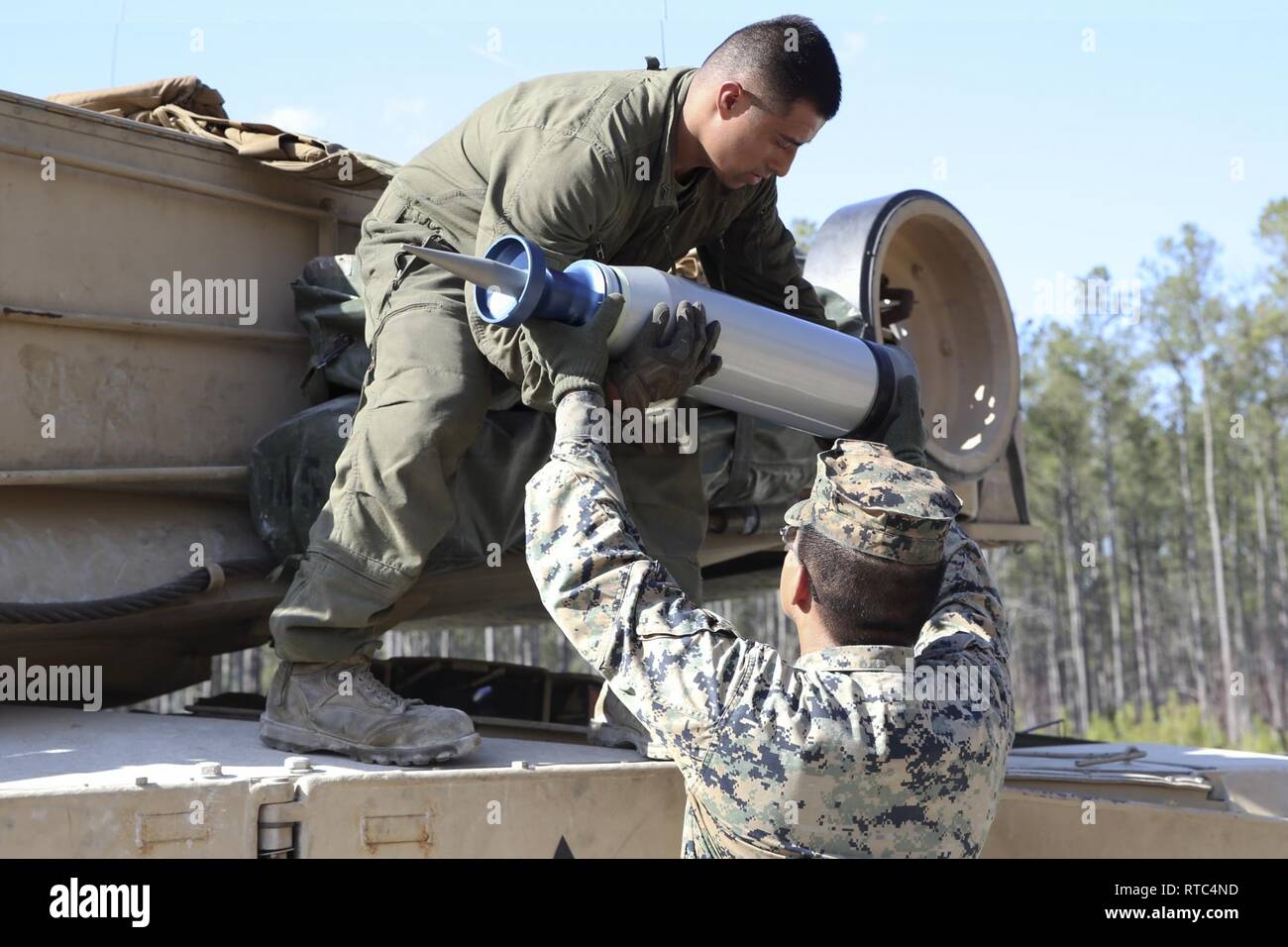 U.S. Marine Cpl. Mascimiliano Reyes, left, tank gunner, 2nd Tank ...