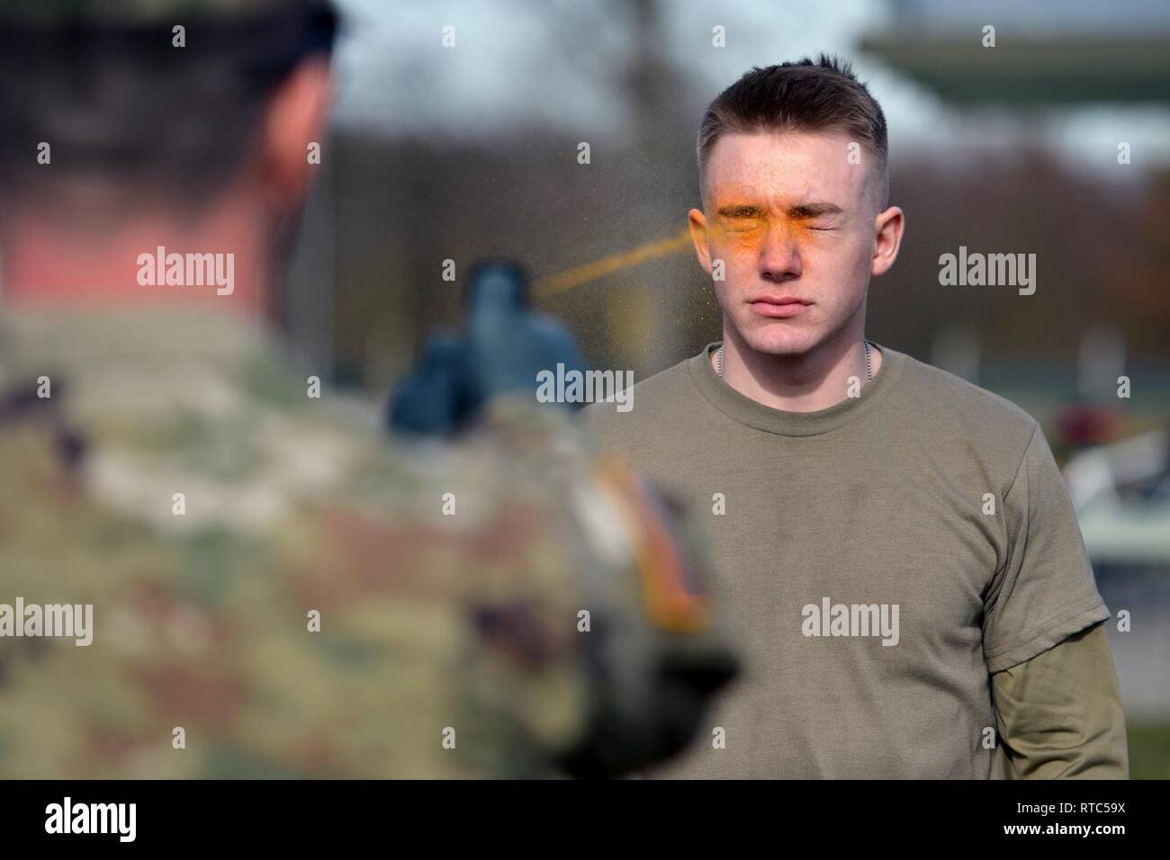 A U.S. Soldier assigned to 554th Military Police Company is sprayed ...