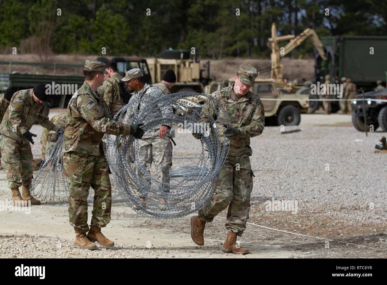 Paratroopers remove constantine wire to load a palette during the ...