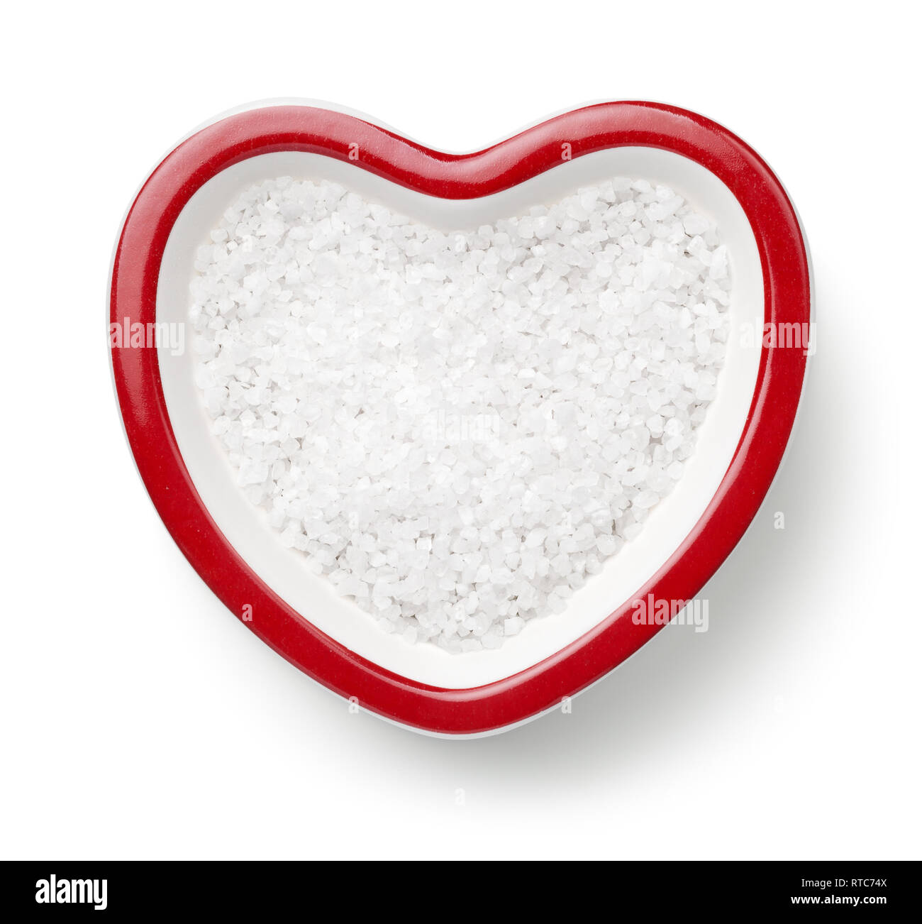 Salt in heart shaped bowl isolated on white background. Top view Stock ...