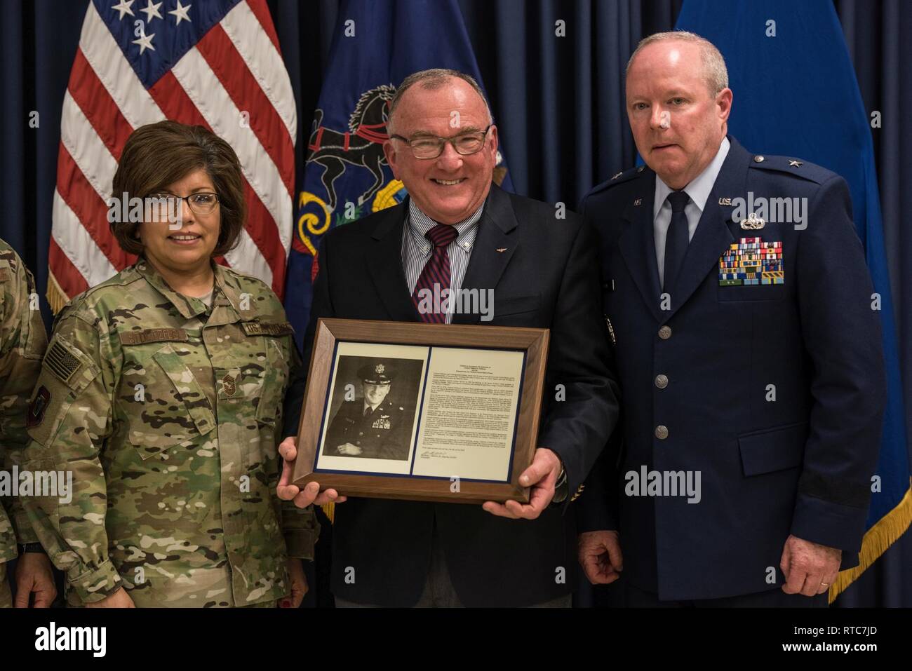 Retired U.S. Air Force Col. Willard G. Dellicker, center, poses for a ...