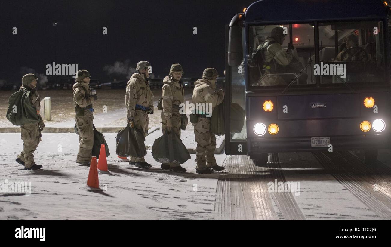 Airmen from the 124th Fighter Wing board a bus to get to their work ...