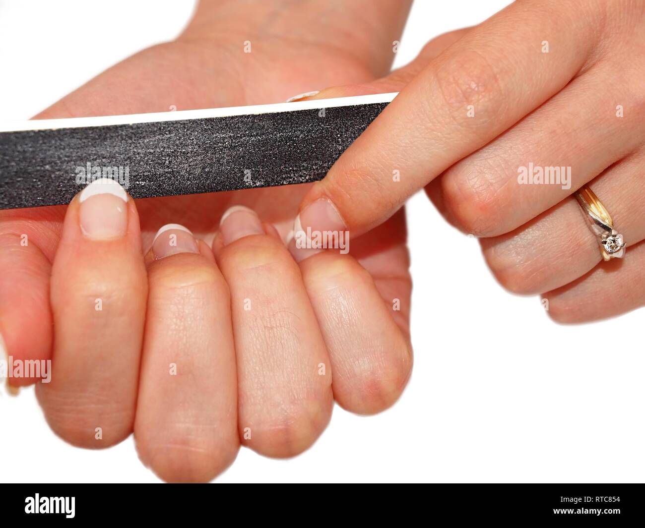 A female is fixing her nails with a nail-file, manicure Stock Photo - Alamy