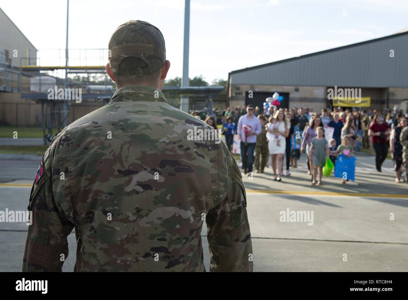 An Airman from the 71st Rescue Squadron walks up to his family after ...