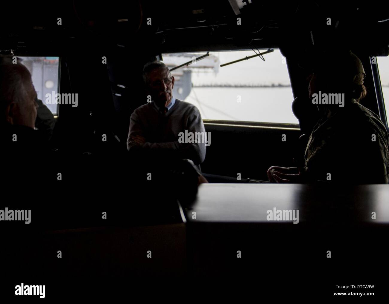 Retired Vice Admiral Timothy LaFleur listens to a brief during a tour ...