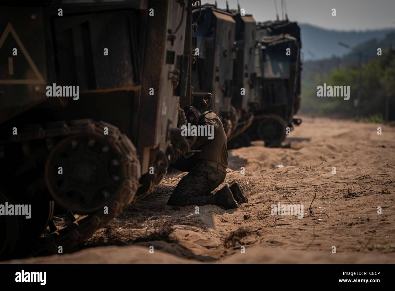 A U.S. Marine inspects assault amphibious vehicles before conducting an ...