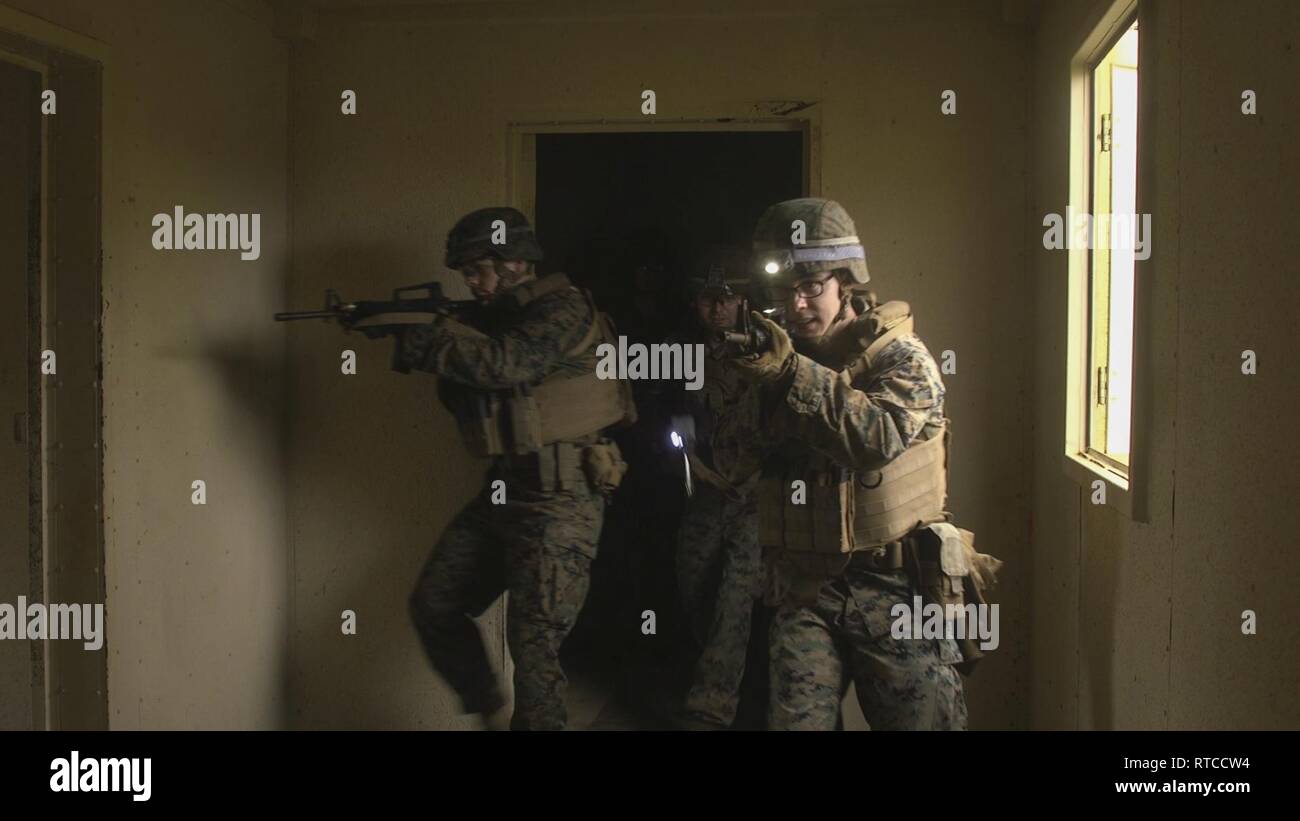 Military Policemen with Combat Logistics Battalion 31 clear a room ...