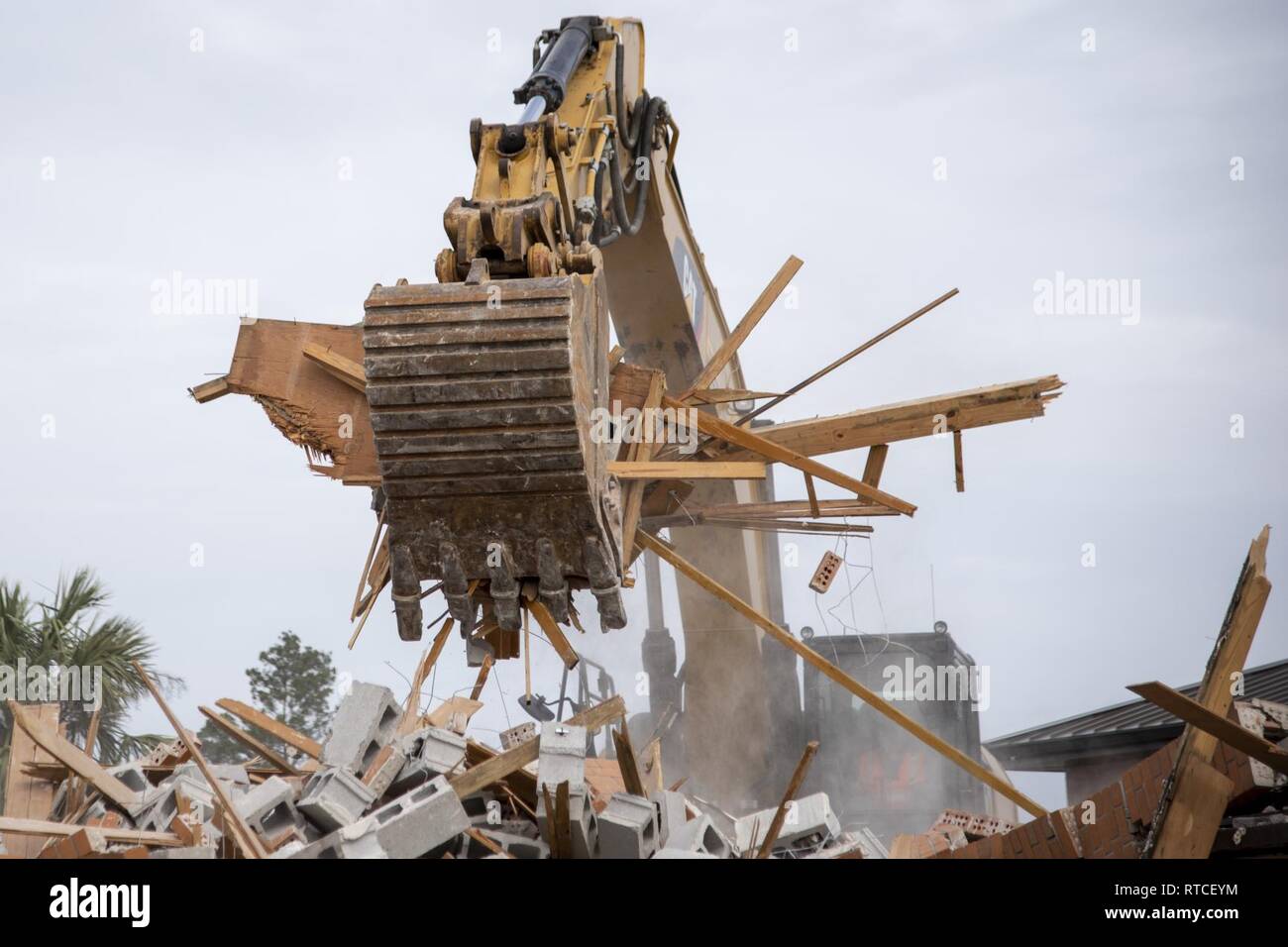 Scott Gilmore, an excavation operator, uses a utility excavator to ...