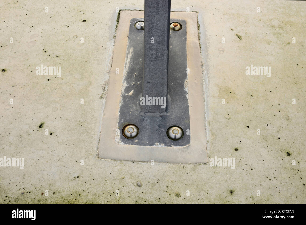 Stainless steel balustrade close up of post fixed to concrete promenade ...