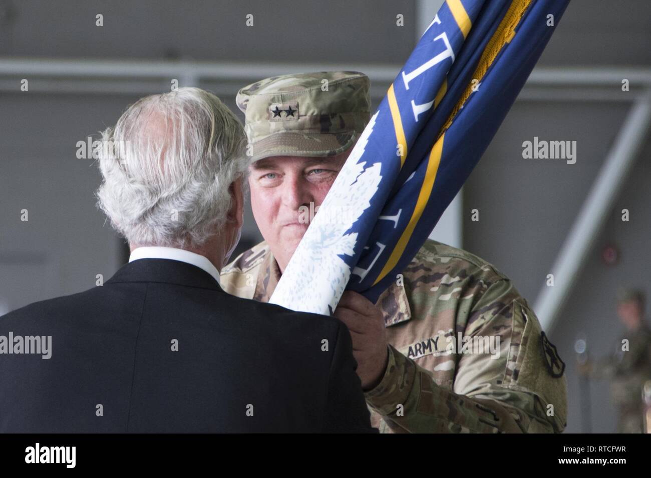 U.S. Army Maj. Gen. Van McCarty receives the colors from Gov. Henry ...