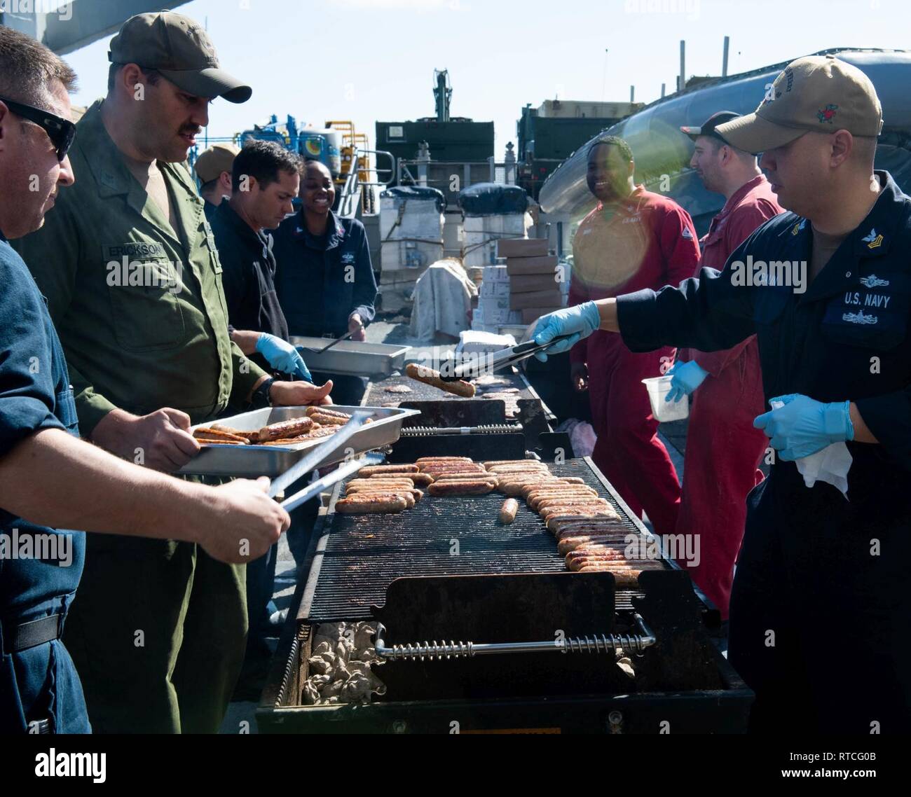 PACIFIC OCEAN (Feb. 16, 2019) Sailors grill hotdogs and burgers during ...