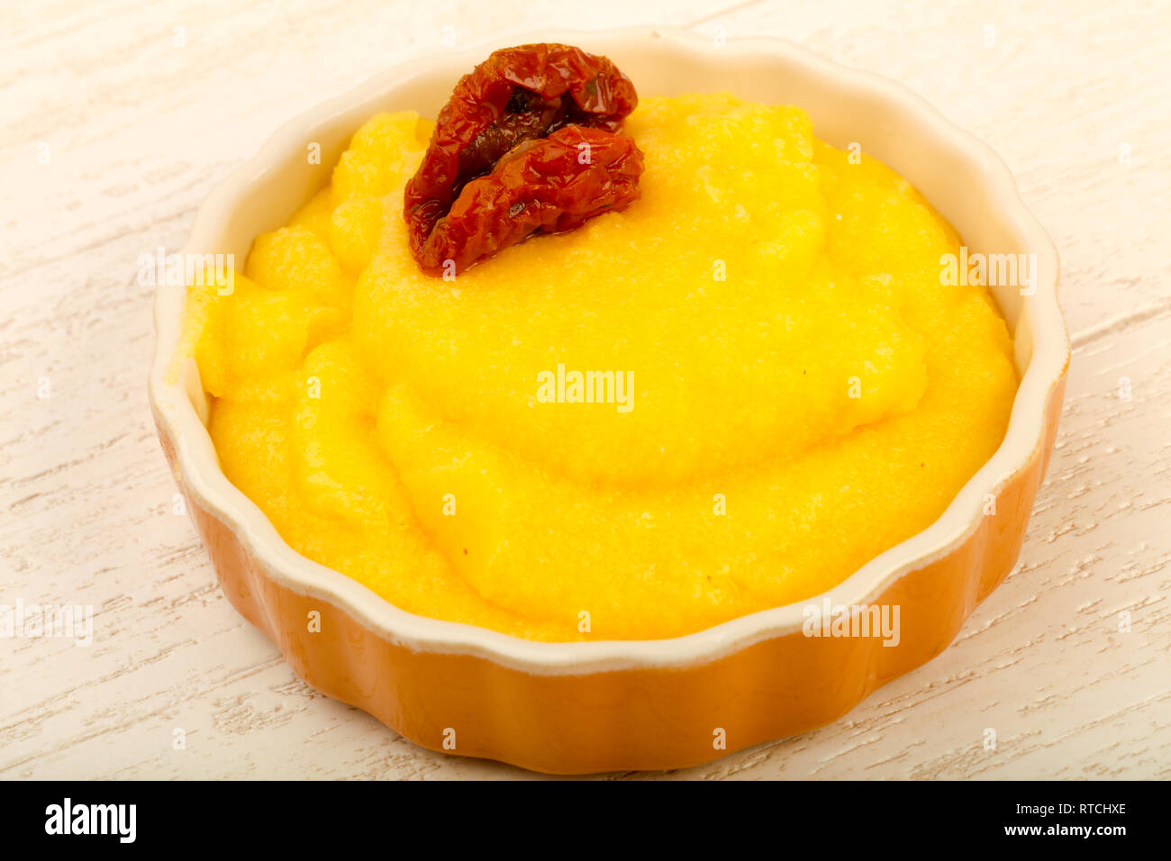 Polenta with dry tomato Stock Photo - Alamy