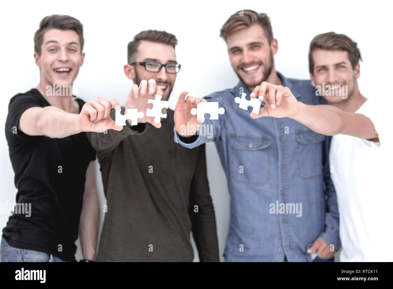 image of the guys connecting pieces of the puzzle Stock Photo - Alamy