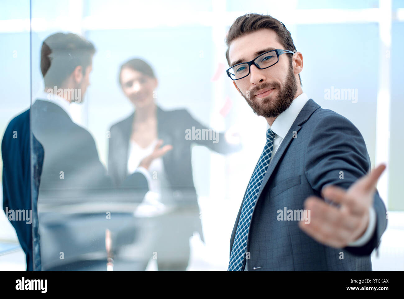 successful businessman inviting to his office Stock Photo - Alamy