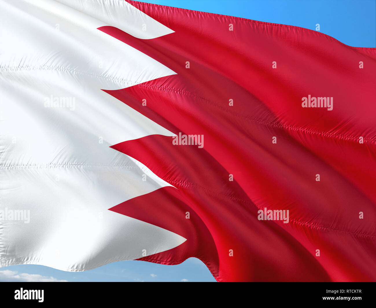 Flag of Bahrain waving in the wind against deep blue sky. High quality ...