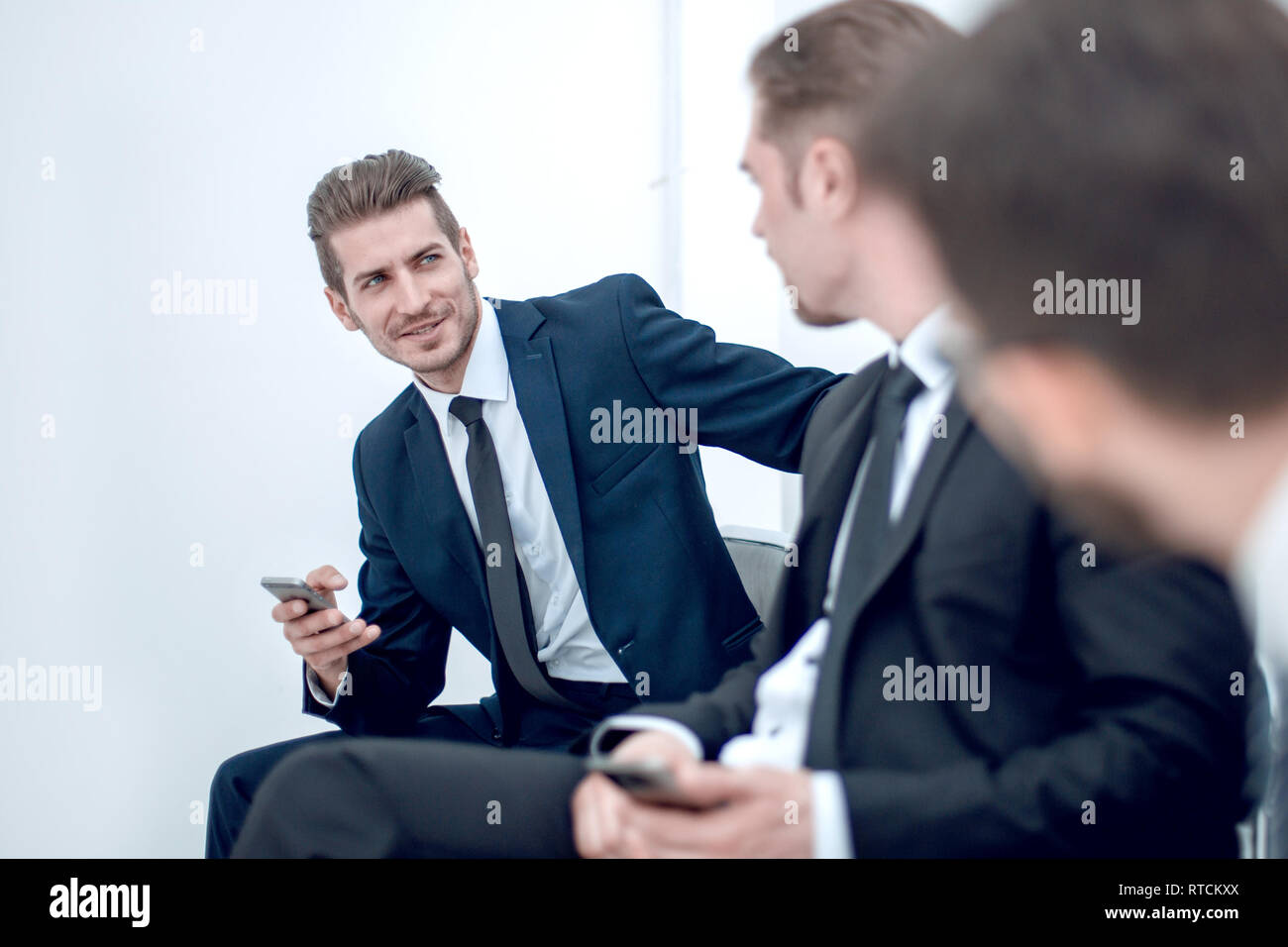 employees sitting in the office hallway Stock Photo - Alamy