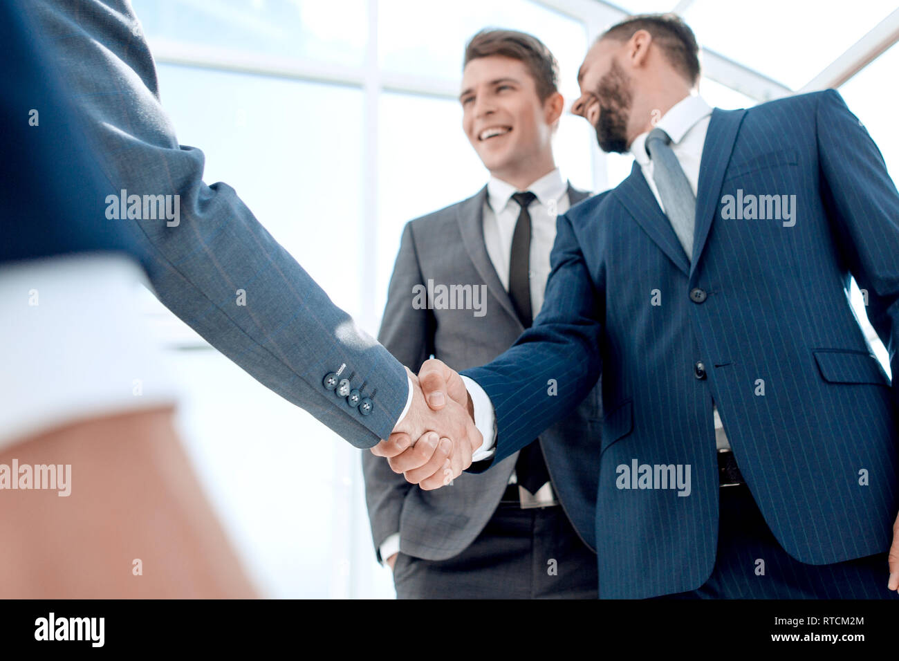 business partners confirming the transaction with their handshake Stock ...