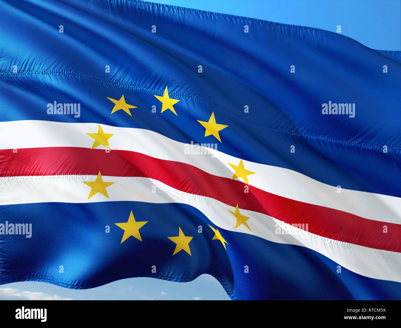 Flag of Cape Verde waving in the wind against deep blue sky. High ...