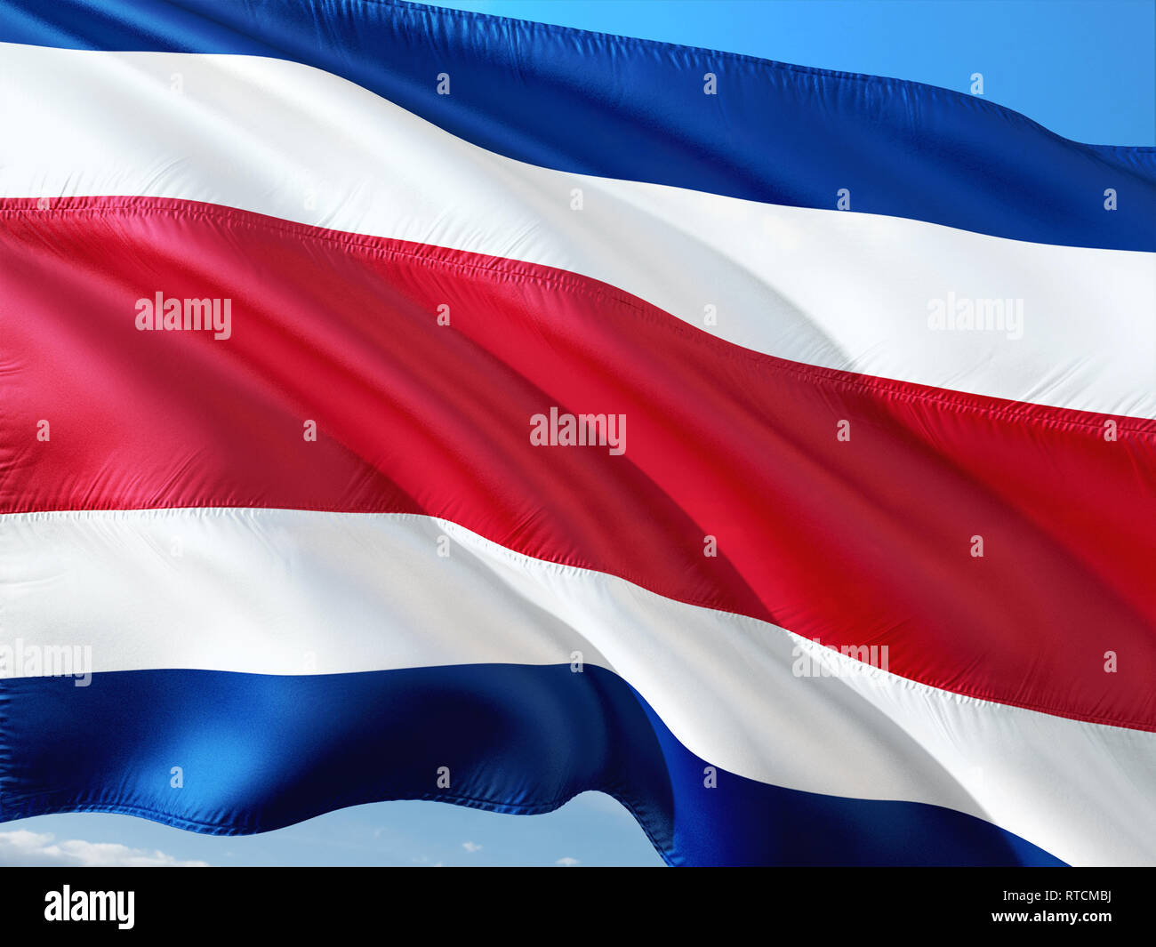 Flag of Costa Rica waving in the wind against deep blue sky. High ...