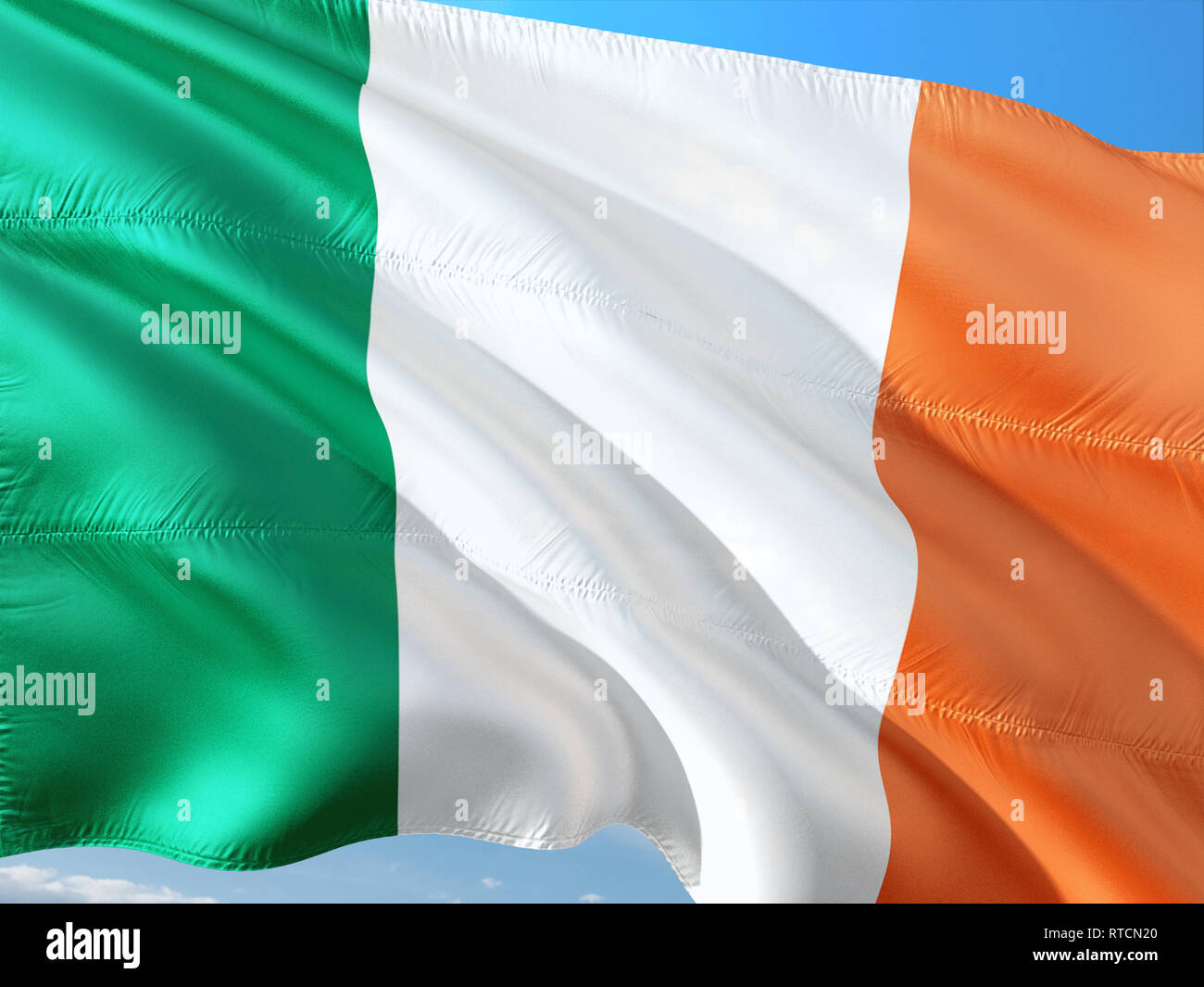 Flag of Ireland waving in the wind against deep blue sky. High quality ...