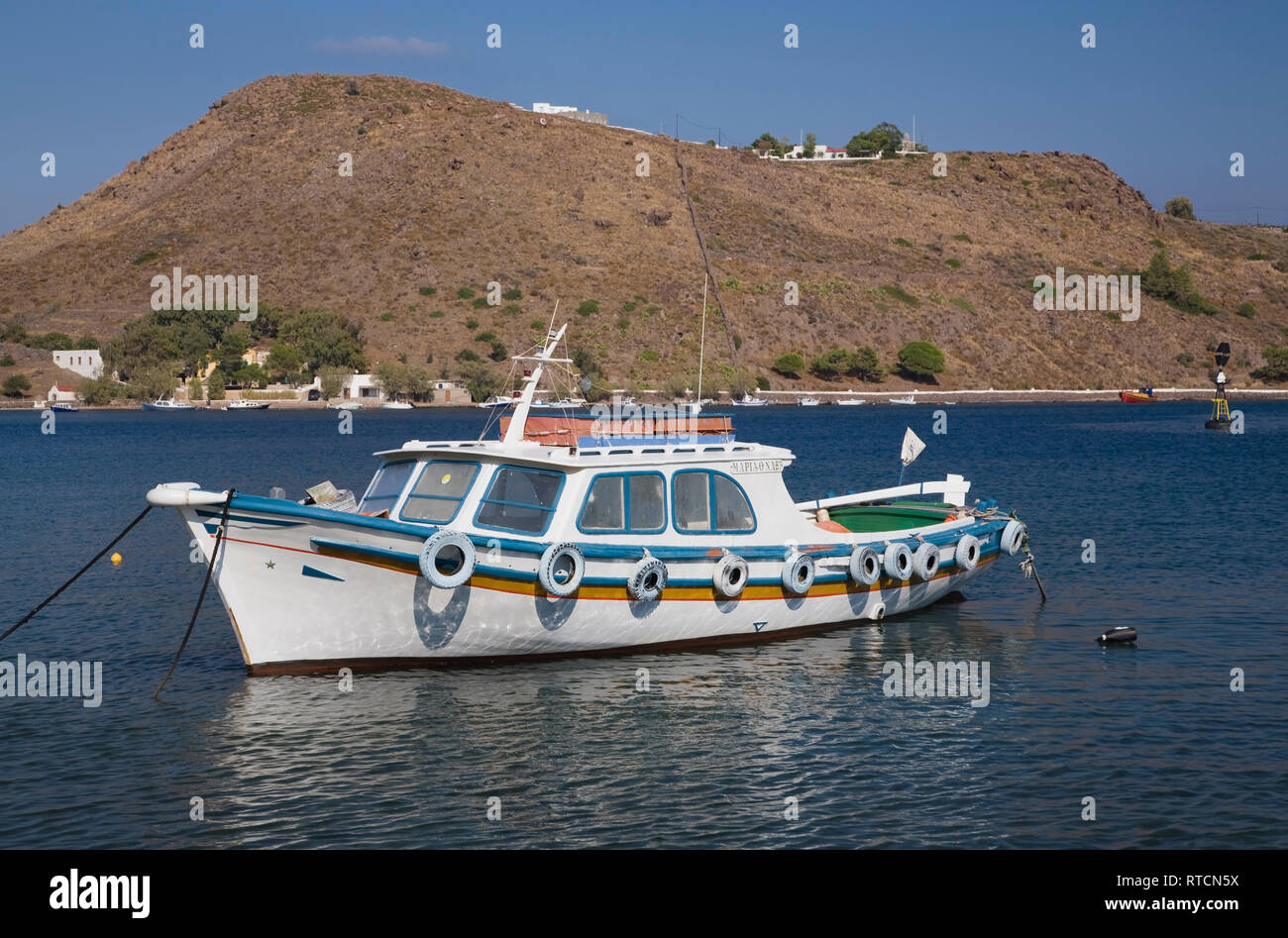 Sightseeing boat anchored in the Port of Patmos, Greece, Europe Stock ...