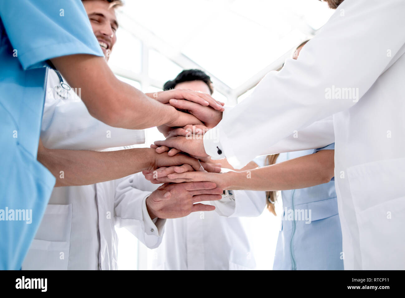 group of doctors with their hands folded together Stock Photo - Alamy