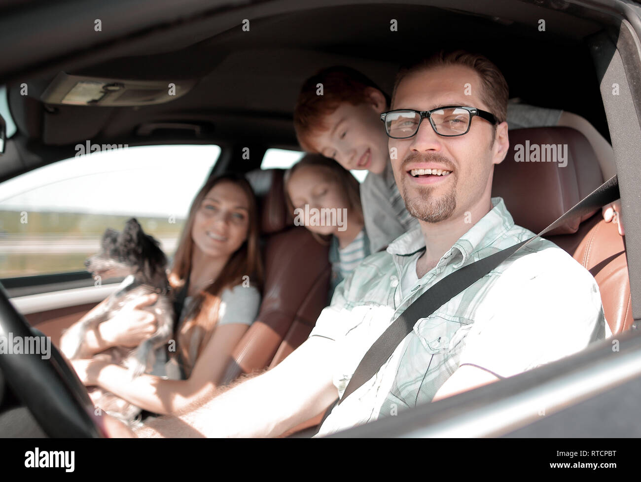 side view.happy father driving a family car Stock Photo - Alamy