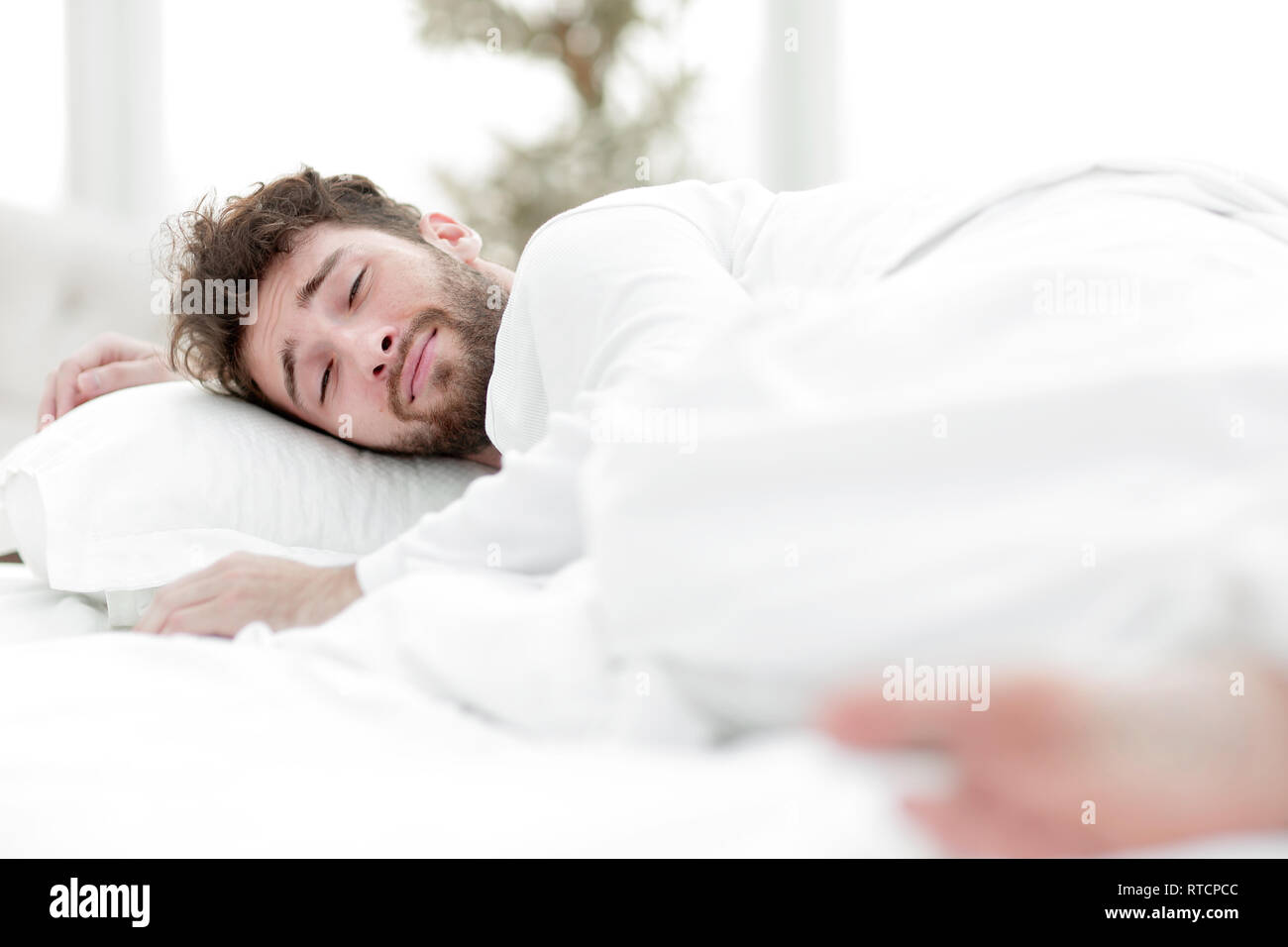 closeup.the tired men sleep soundly on the bed Stock Photo - Alamy