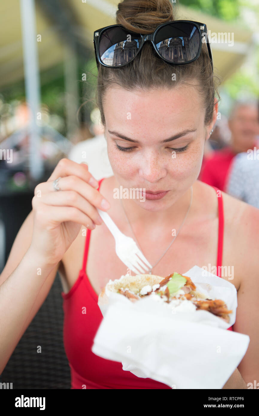 pretty girl or Woman eating sandwich gyros. Girl with pleasure eats ...