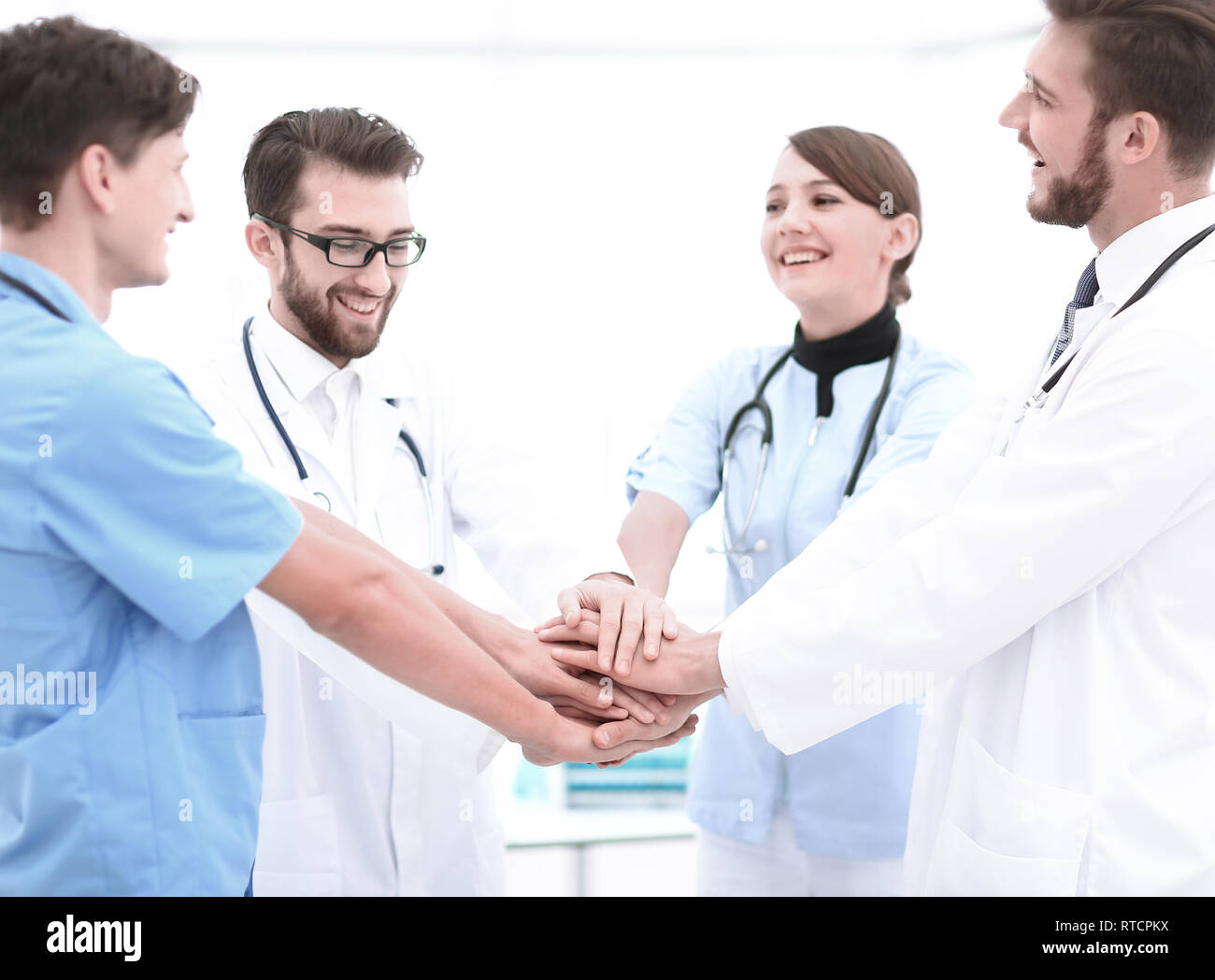doctors holding hands together at hospital Stock Photo - Alamy