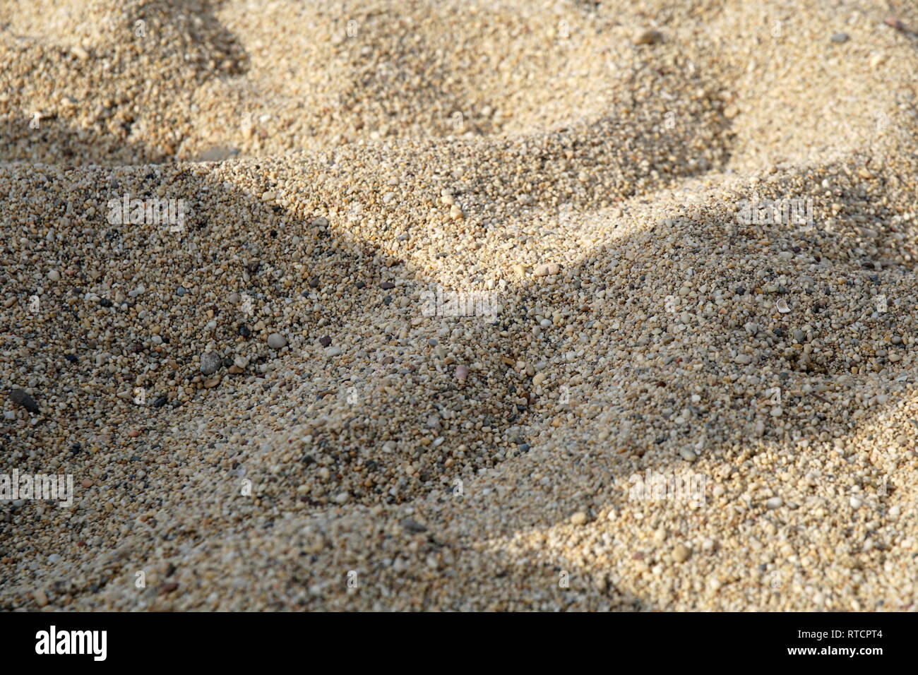 Sand surface background on the beach. Small sand stone of sand wall ...