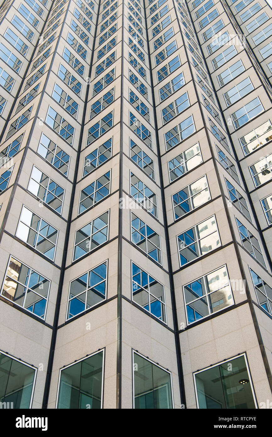 perspective wide angle view to steel blue background of glass high rise ...