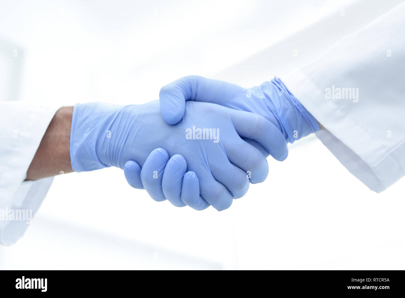 hand in the medical glove (handshake Stock Photo - Alamy