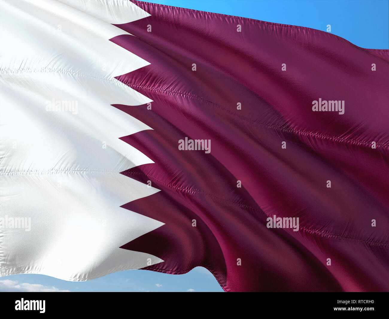 Flag of Qatar waving in the wind against deep blue sky. High quality ...