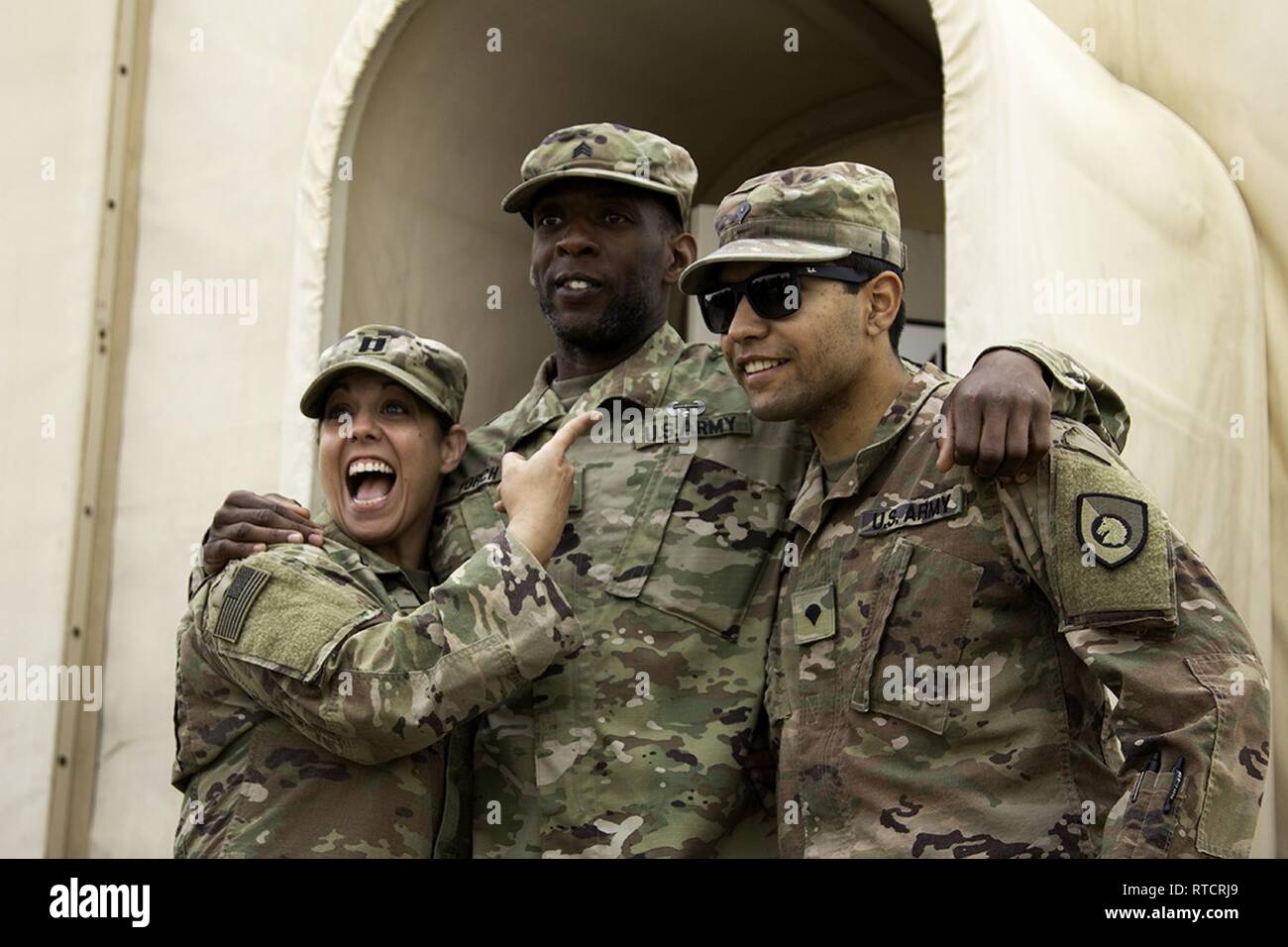 Sgt. Mayso Porch takes a picture with Capt. Christina Calello and Spc ...