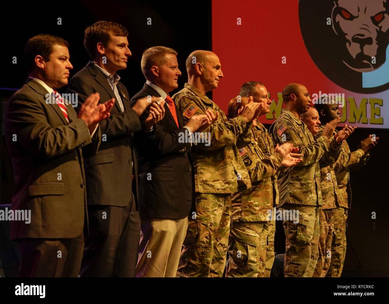 Distinguished speakers and guests applaud at the return of the 130th ...