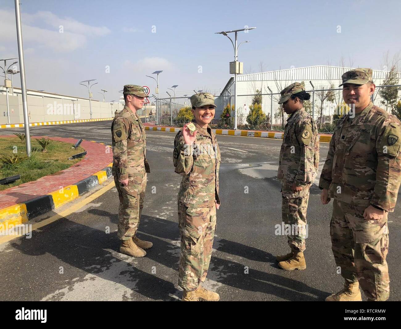 Sgt. Kayla Baker, 657th Movement Control Team, receives a coin for ...