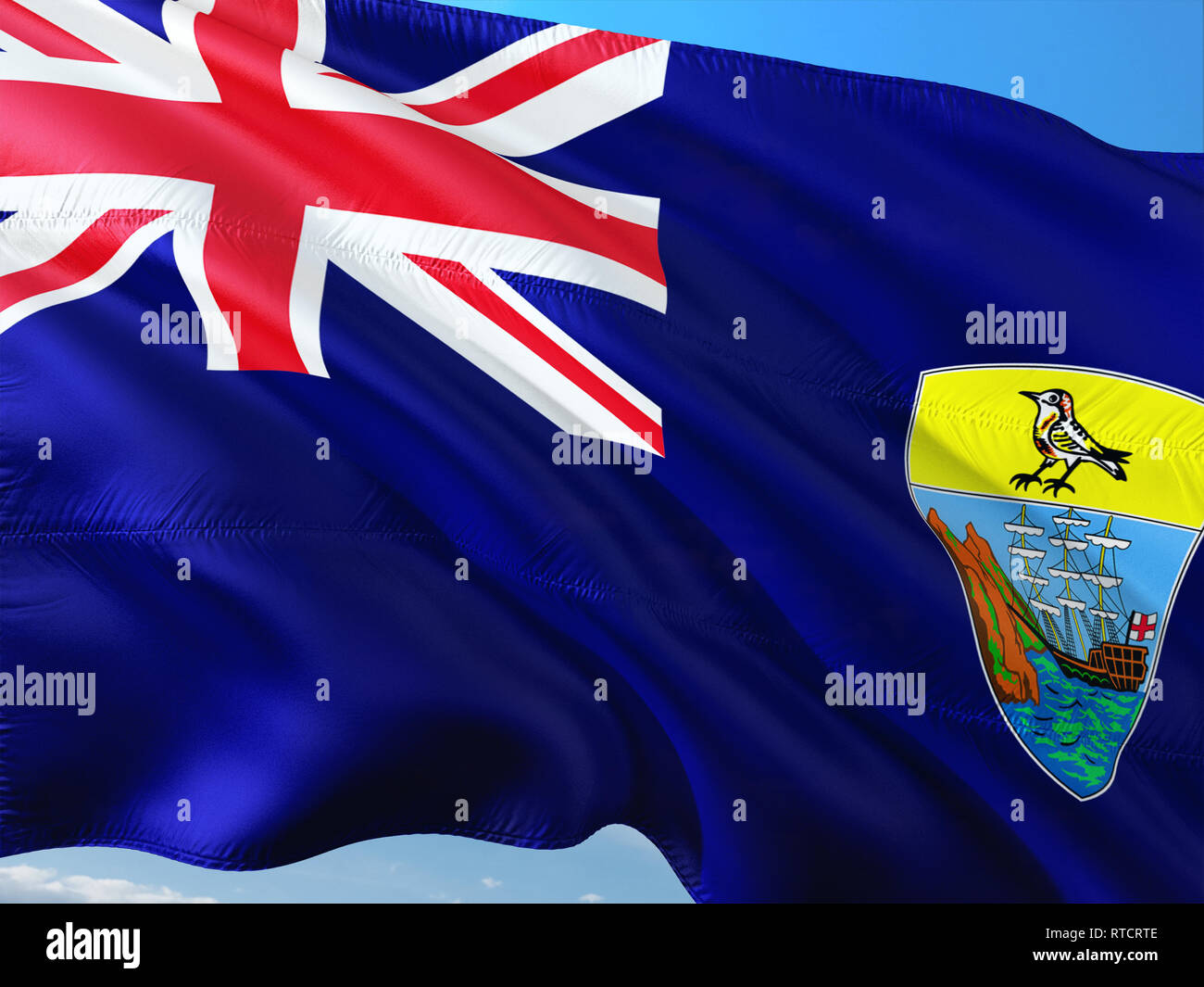 Flag of Saint Helena waving in the wind against deep blue sky. High ...