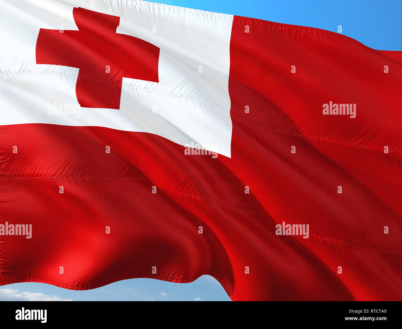 Flag of Tonga waving in the wind against deep blue sky. High quality ...