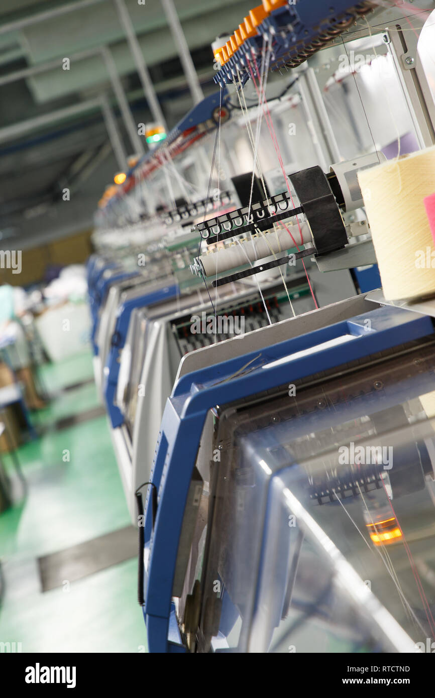 Textile industry with knitting machines in factory Stock Photo - Alamy