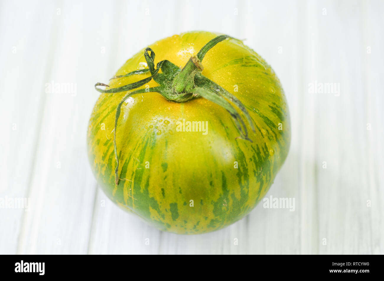 Fresh, green zebra tomato Stock Photo - Alamy