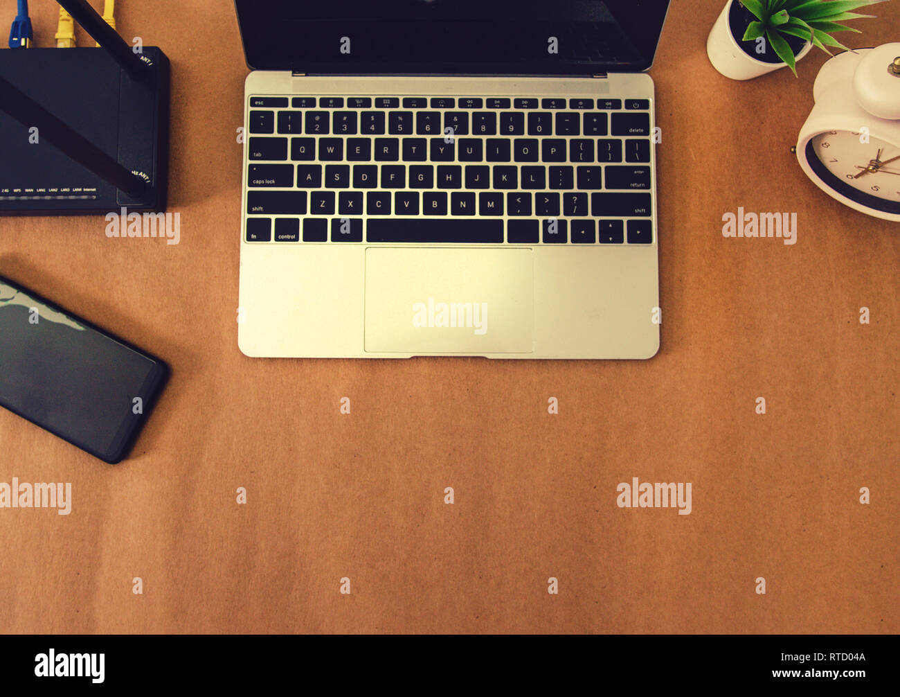 flat lay Office table with wifi router, computer and supplies top view ...