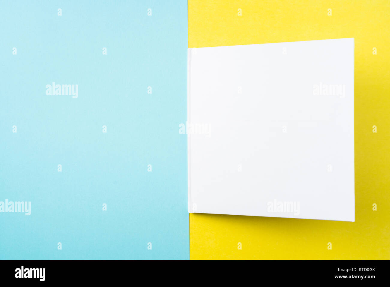 Design concept - Top view of opening square white notebook on colorful ...